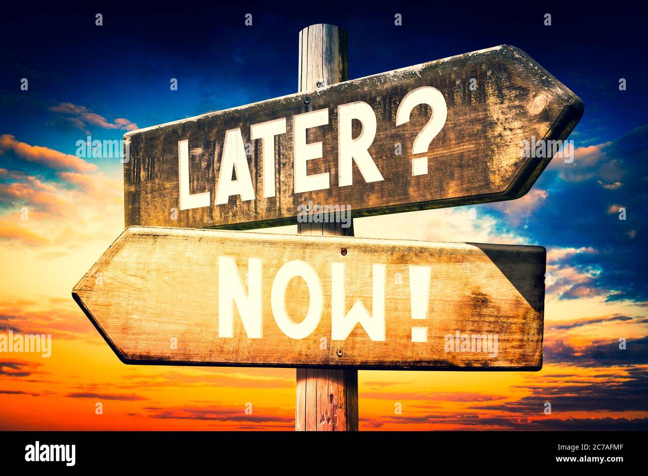 Later? Now! - wooden signpost, roadsign with two arrows Stock Photo - Alamy