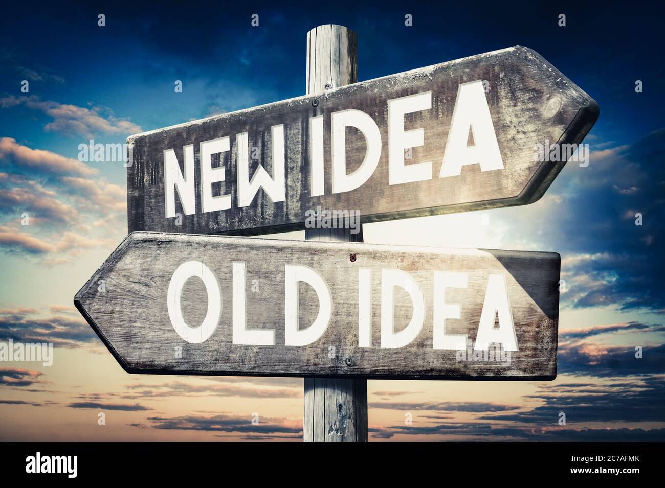 New idea, old idea - wooden signpost, roadsign with two arrows Stock ...