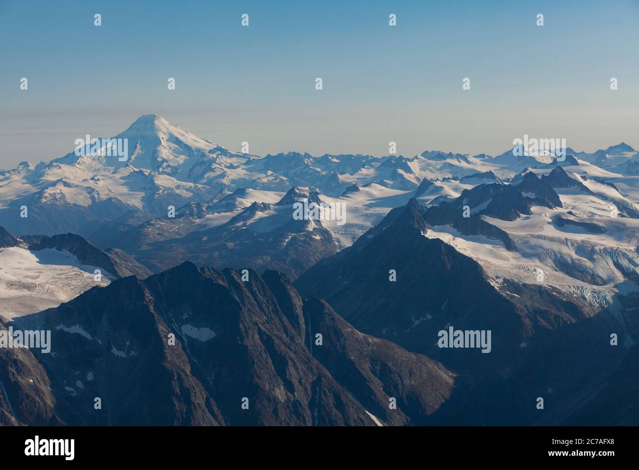 An aerial view of Alaska's majestic snow-capped mountains and glacial ...