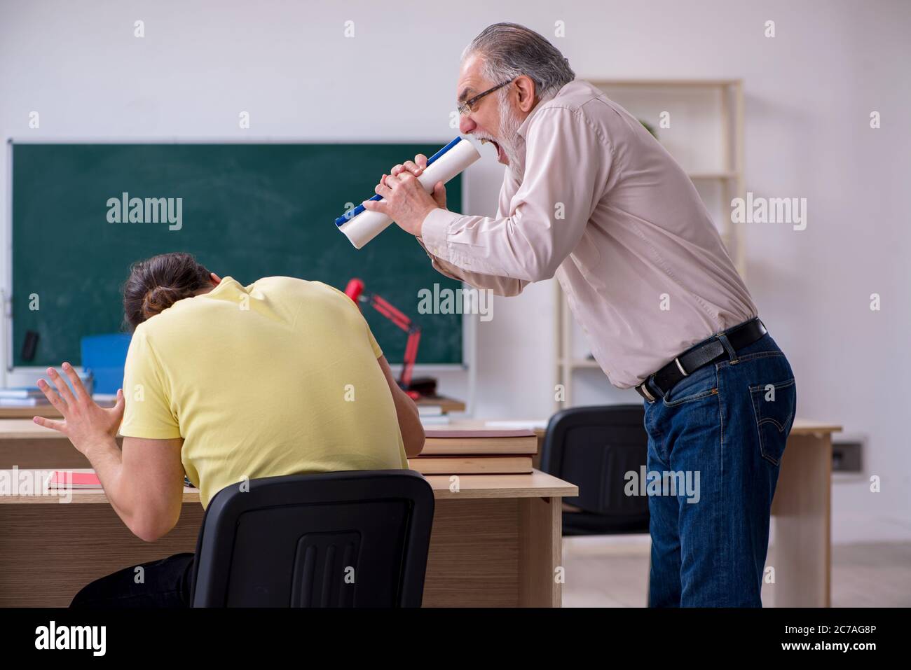 Old teacher and young student in the classroom Stock Photo - Alamy