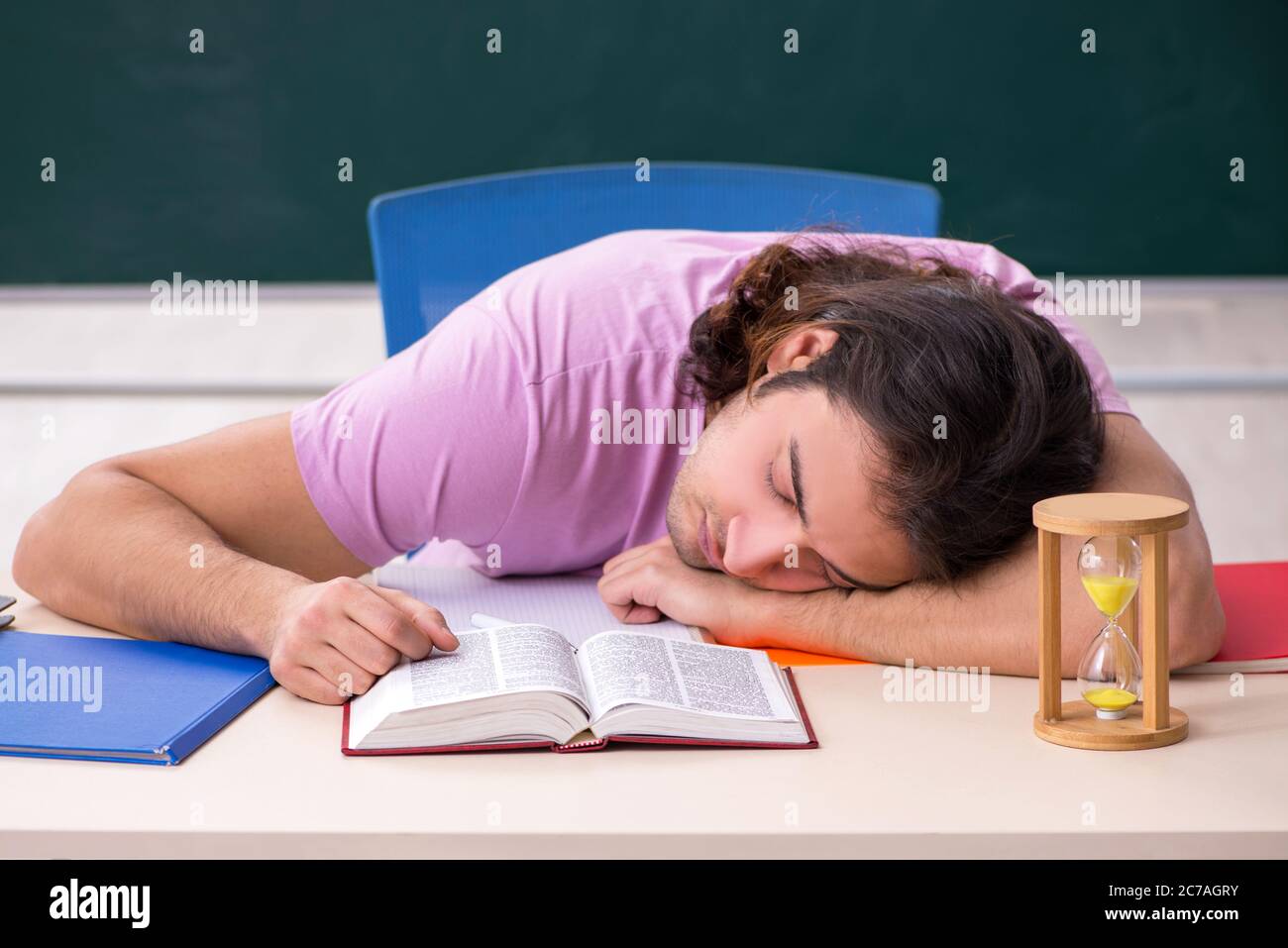 Young student in the classroom at time management concept Stock Photo ...