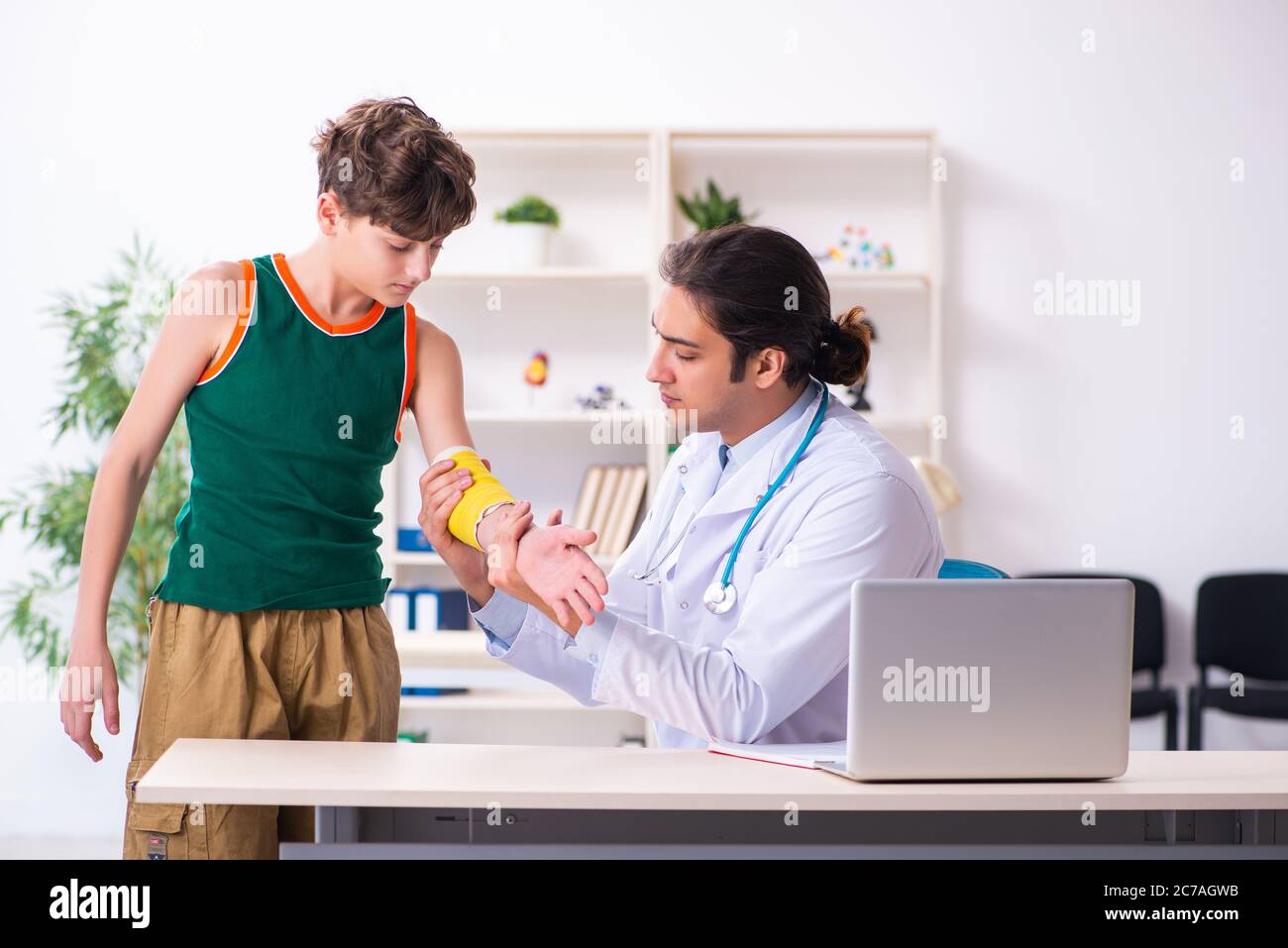 Sick boy visiting young doctor pediatrician Stock Photo - Alamy