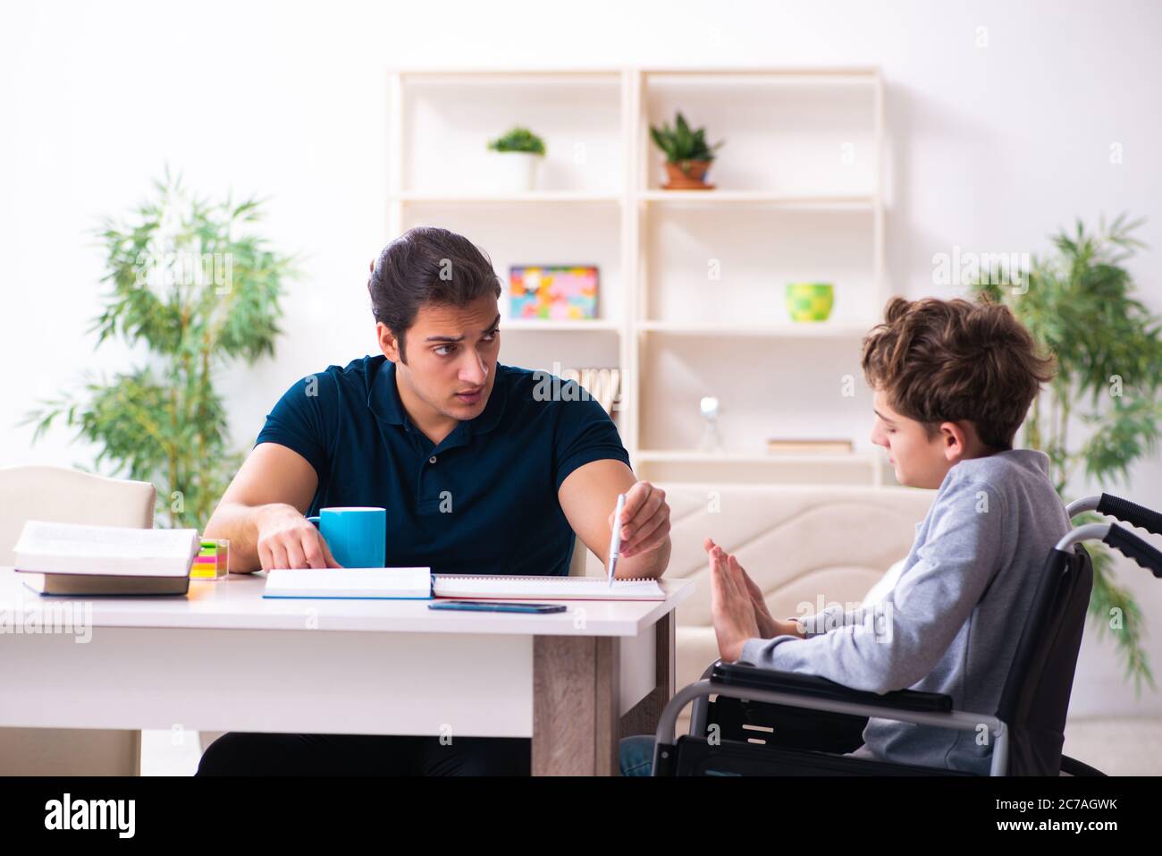 Father and disabled son in the education concept Stock Photo - Alamy
