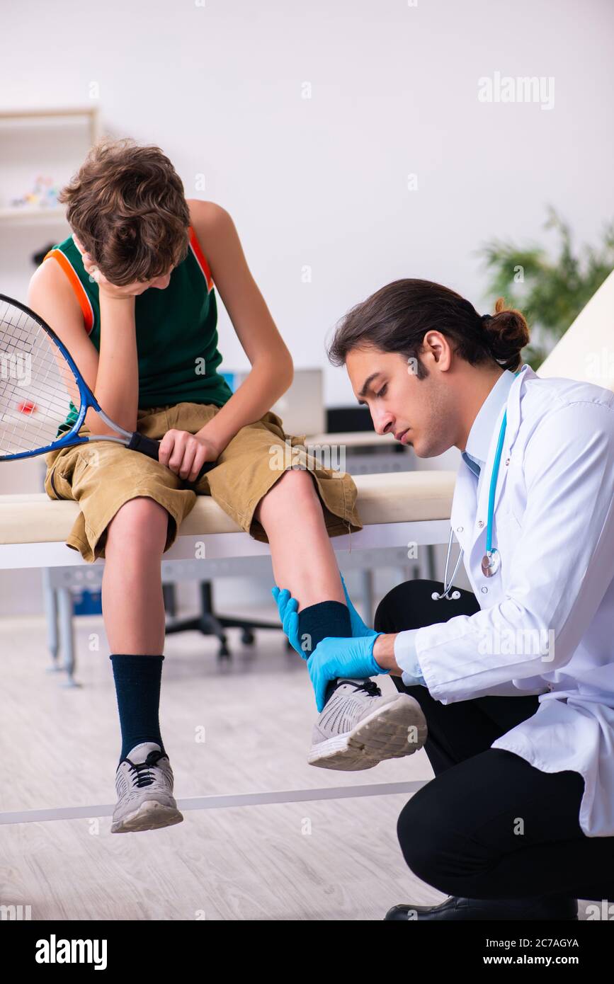 Sick boy visiting young doctor pediatrician Stock Photo - Alamy