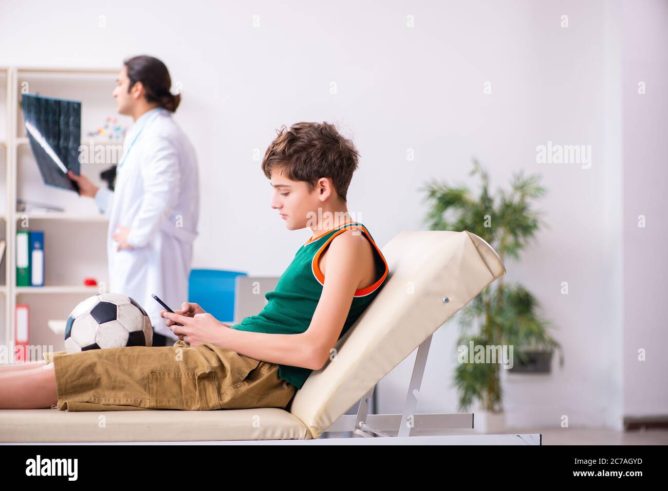Sick boy visiting young doctor pediatrician Stock Photo - Alamy
