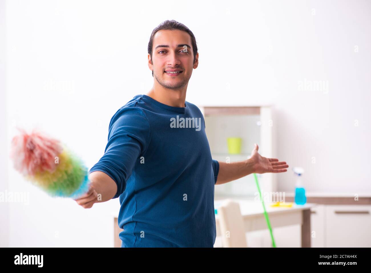 Young man husband doing housework at the home Stock Photo - Alamy