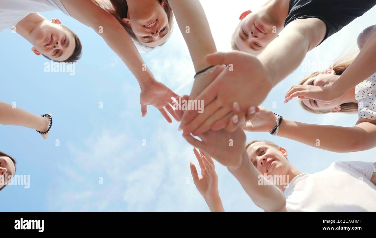 Friendly friends clasp hands as a sign of strong friendship and ...