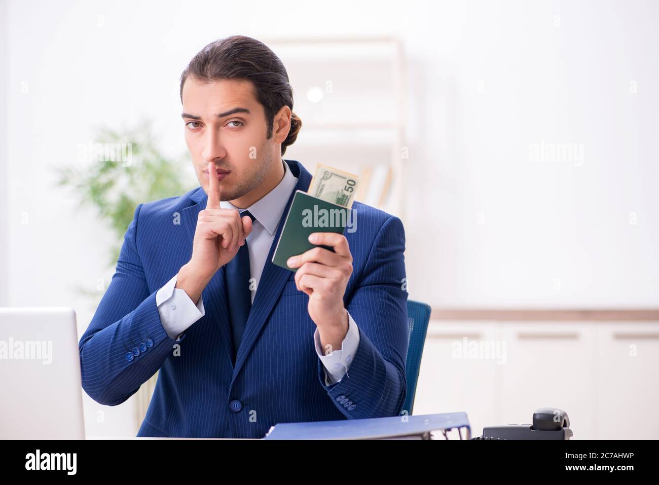 Young man receiving bribery for the visa approval Stock Photo - Alamy