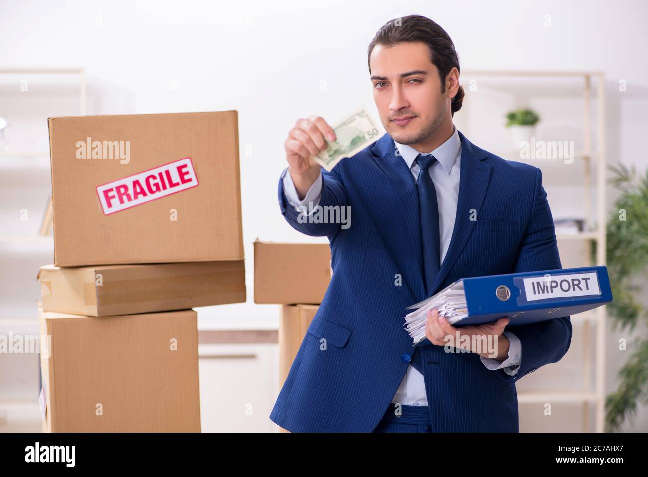 Young logistics specialist working in the office Stock Photo - Alamy