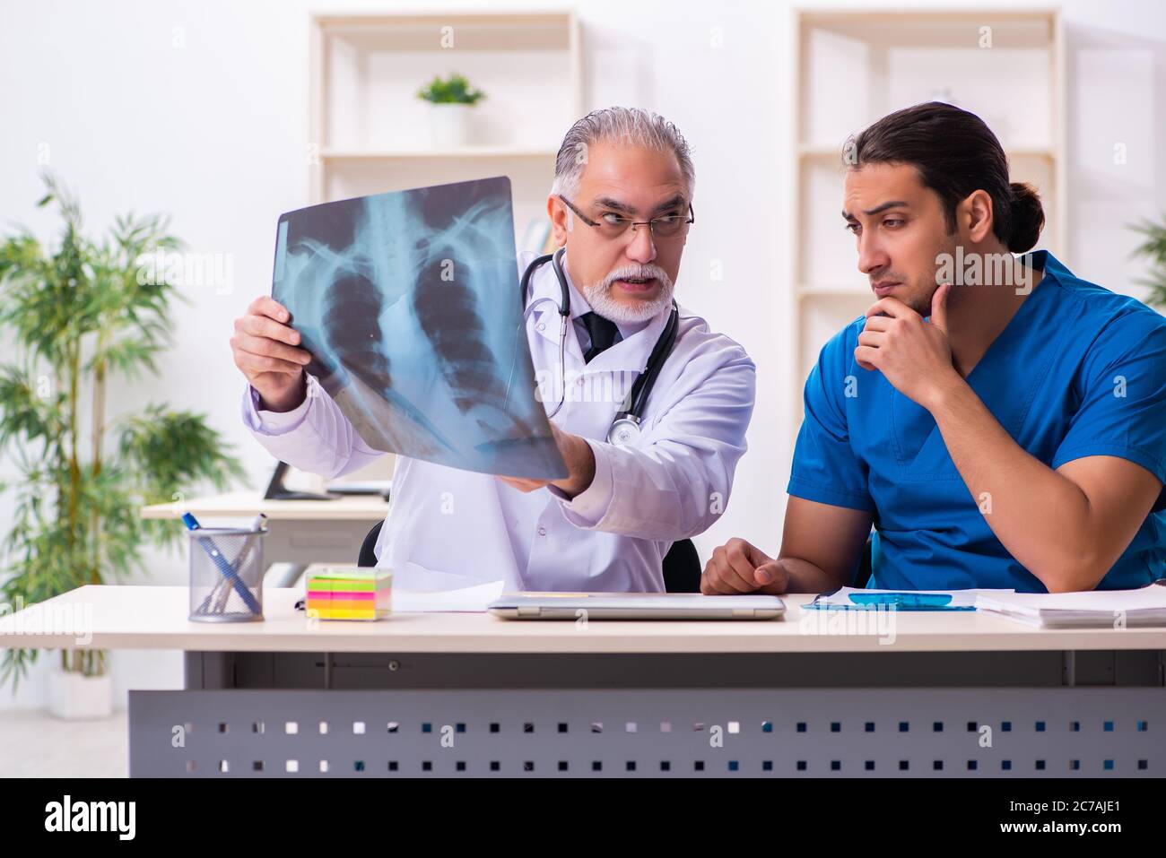 Two male doctors working in the modern clinic Stock Photo - Alamy
