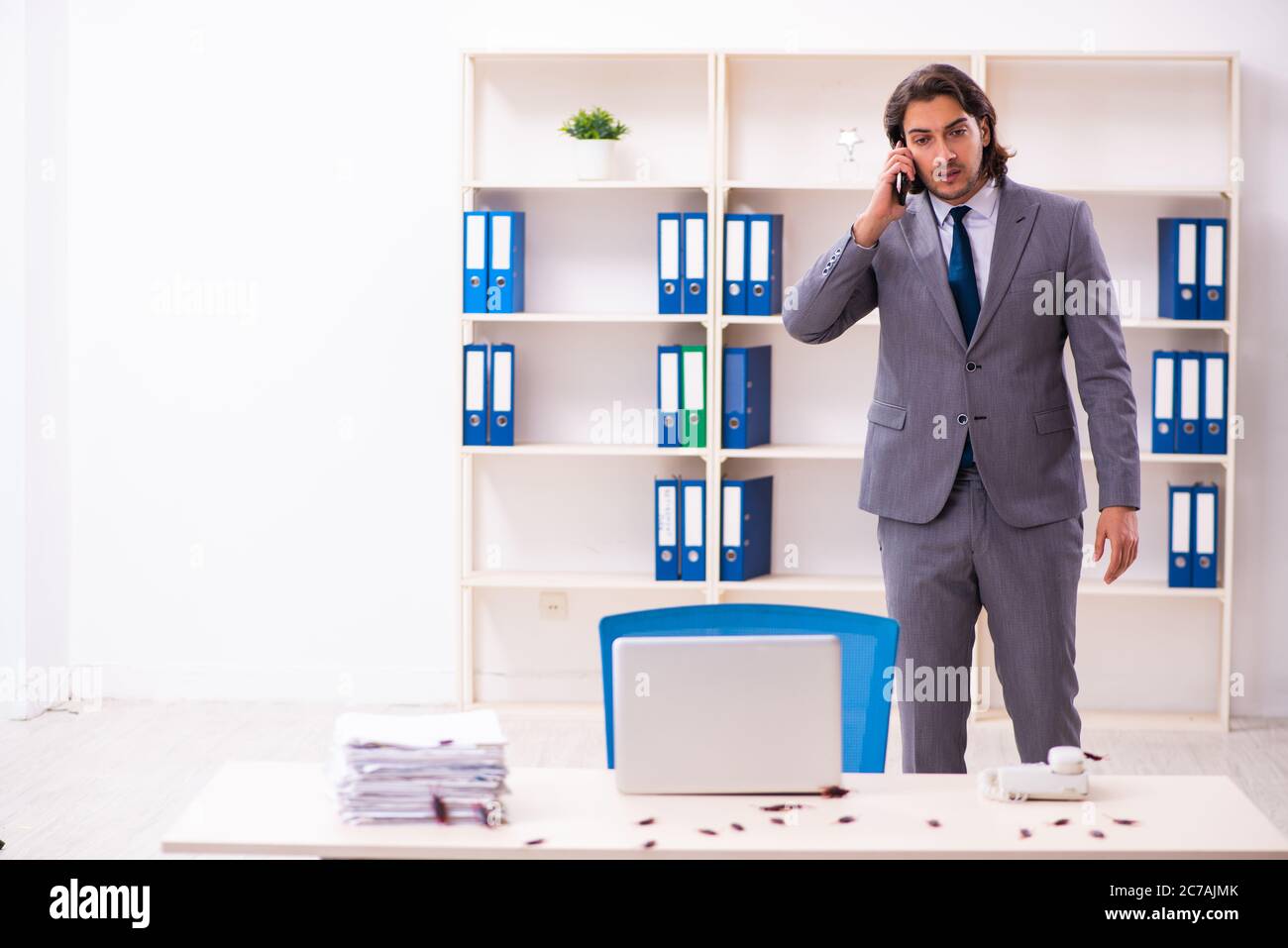 Young employee and too many cockroaches in the office Stock Photo - Alamy