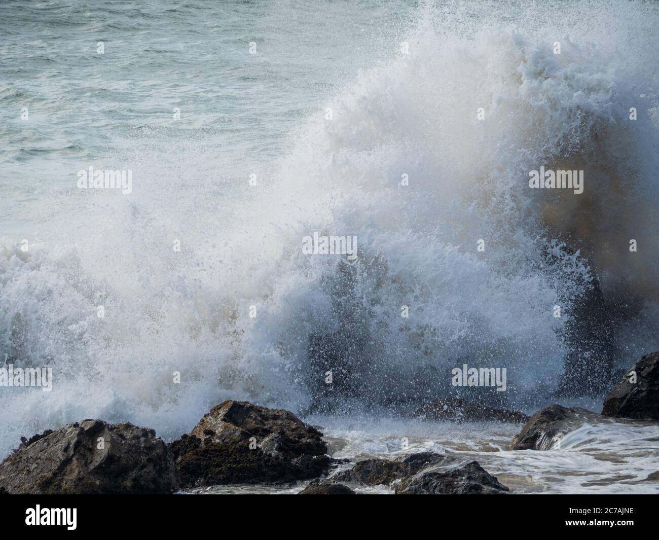 Stormy water, rough seas, closeup ocean waves crashing up against rocks ...