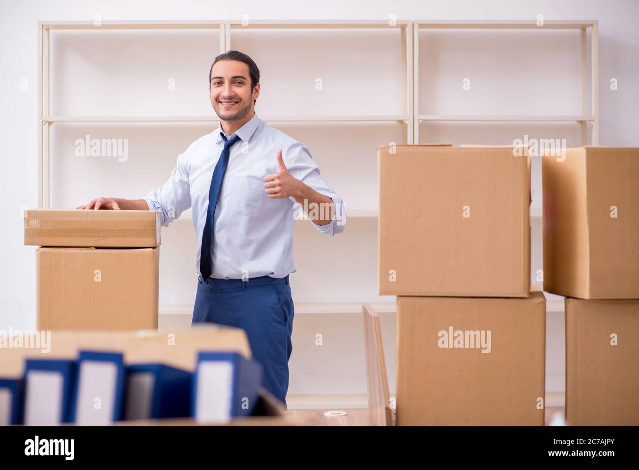 Young employee in relocation concept Stock Photo - Alamy