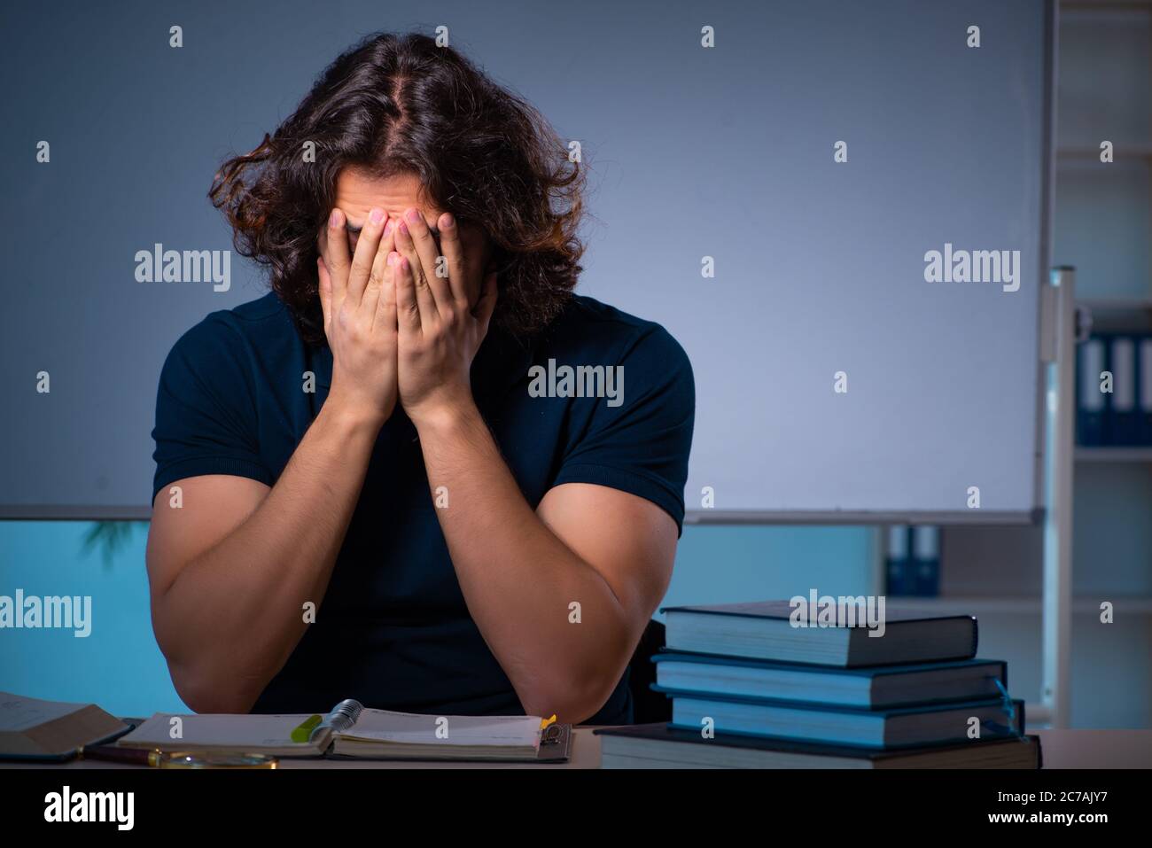 Young student in the classroom at night Stock Photo - Alamy
