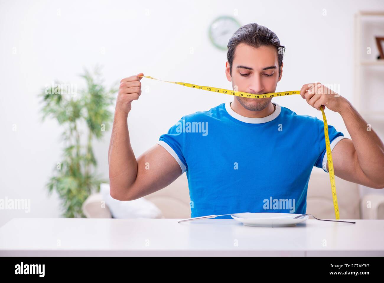 Hungry young man waiting dinner hi-res stock photography and images - Alamy