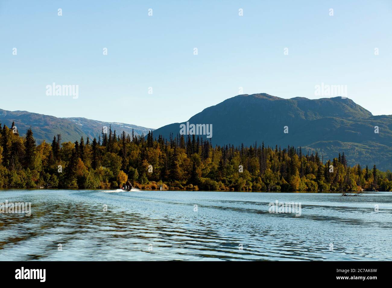 Lake Iliamna, Alaska, under a clear blue sky, with calm waters ...