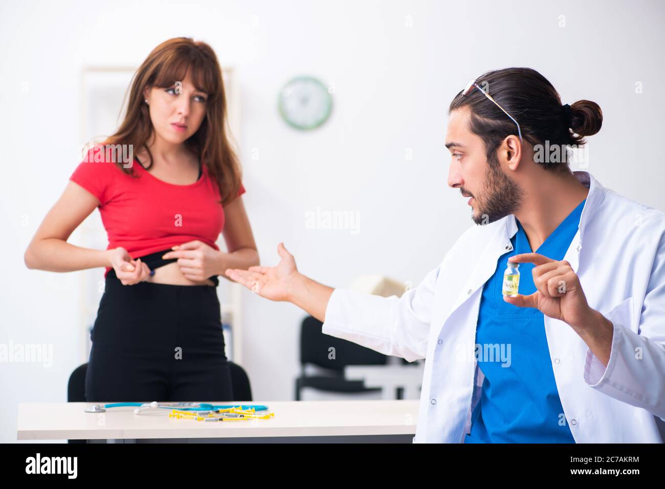 Female diabetic patient visiting young doctor Stock Photo - Alamy