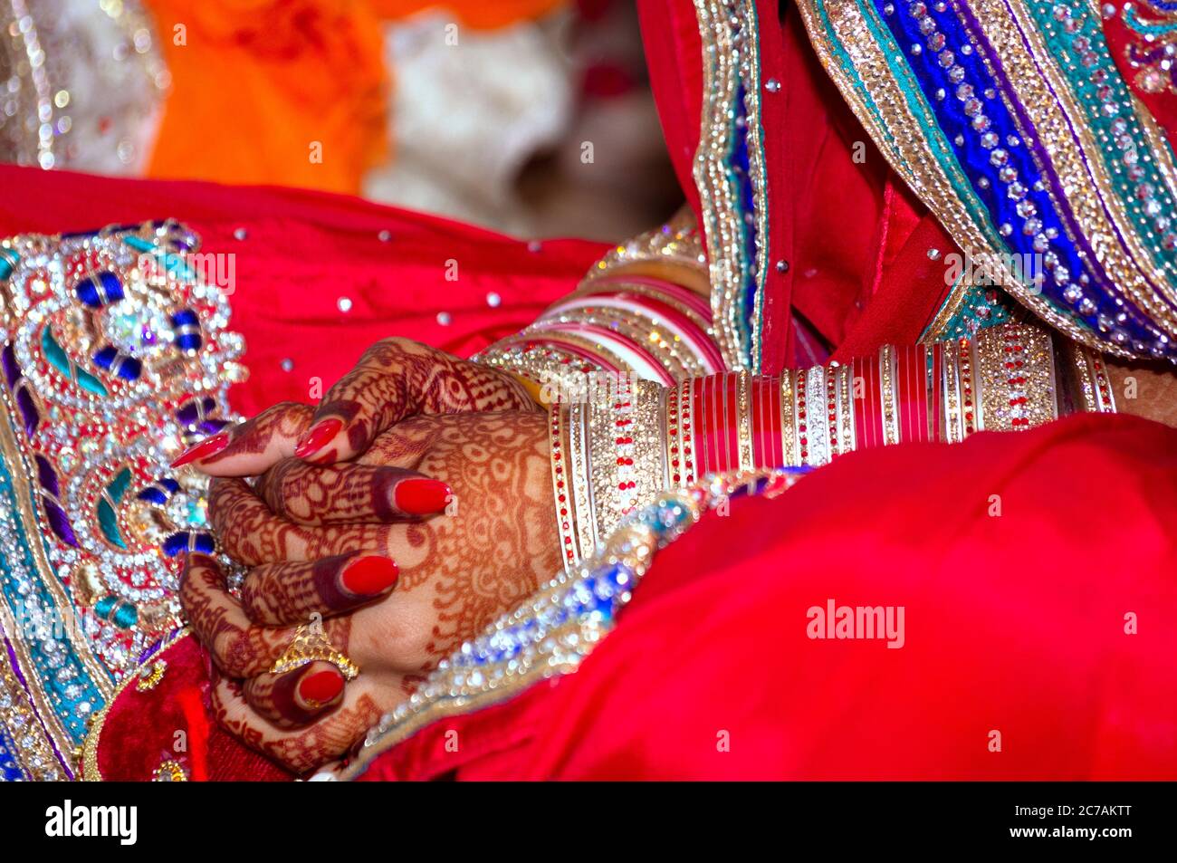 Sikh wedding ceremony - hands with rings and other traditional ...