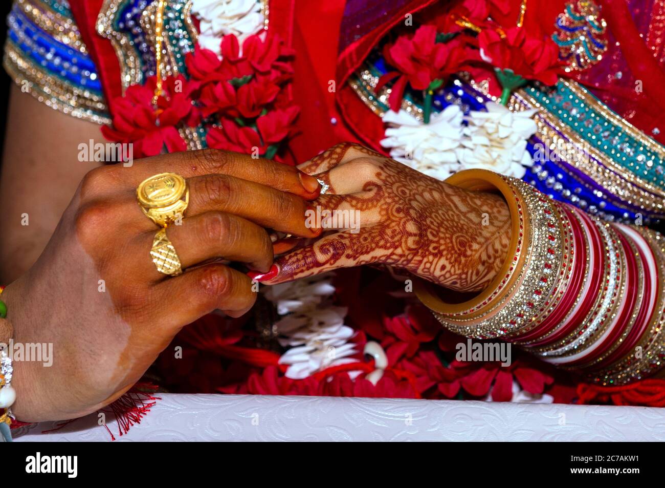Sikh wedding ceremony - hands with rings and other traditional ...