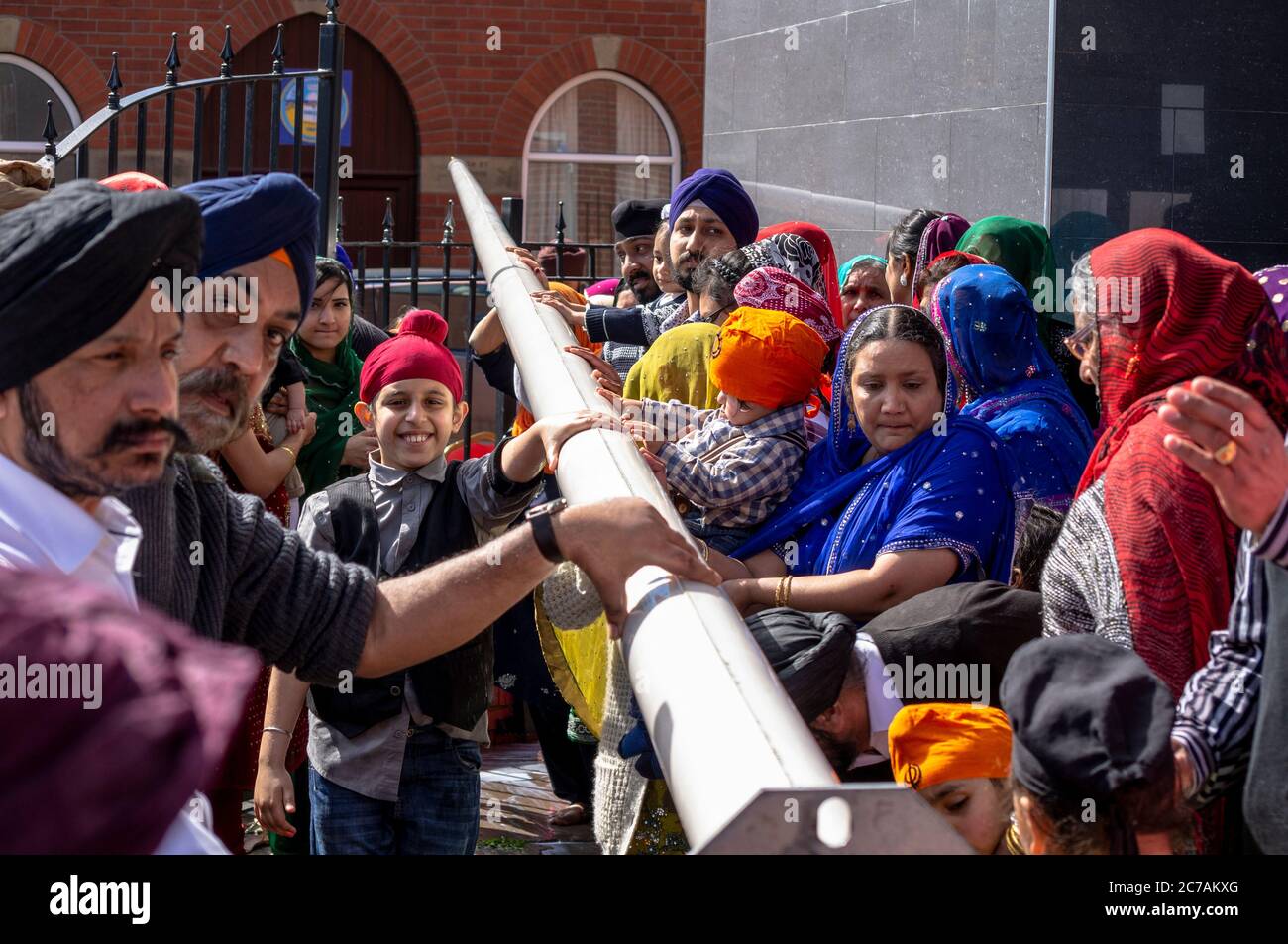 The Sikh cleaning a mast with the traditional Gurdwara flag Stock Photo ...