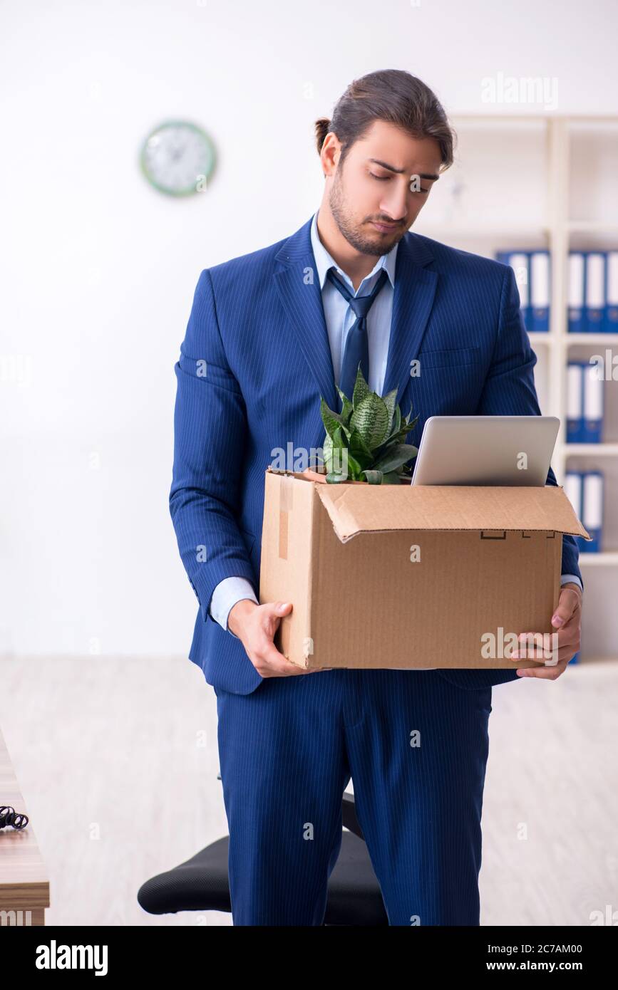 Young man being fired from his workplace Stock Photo - Alamy