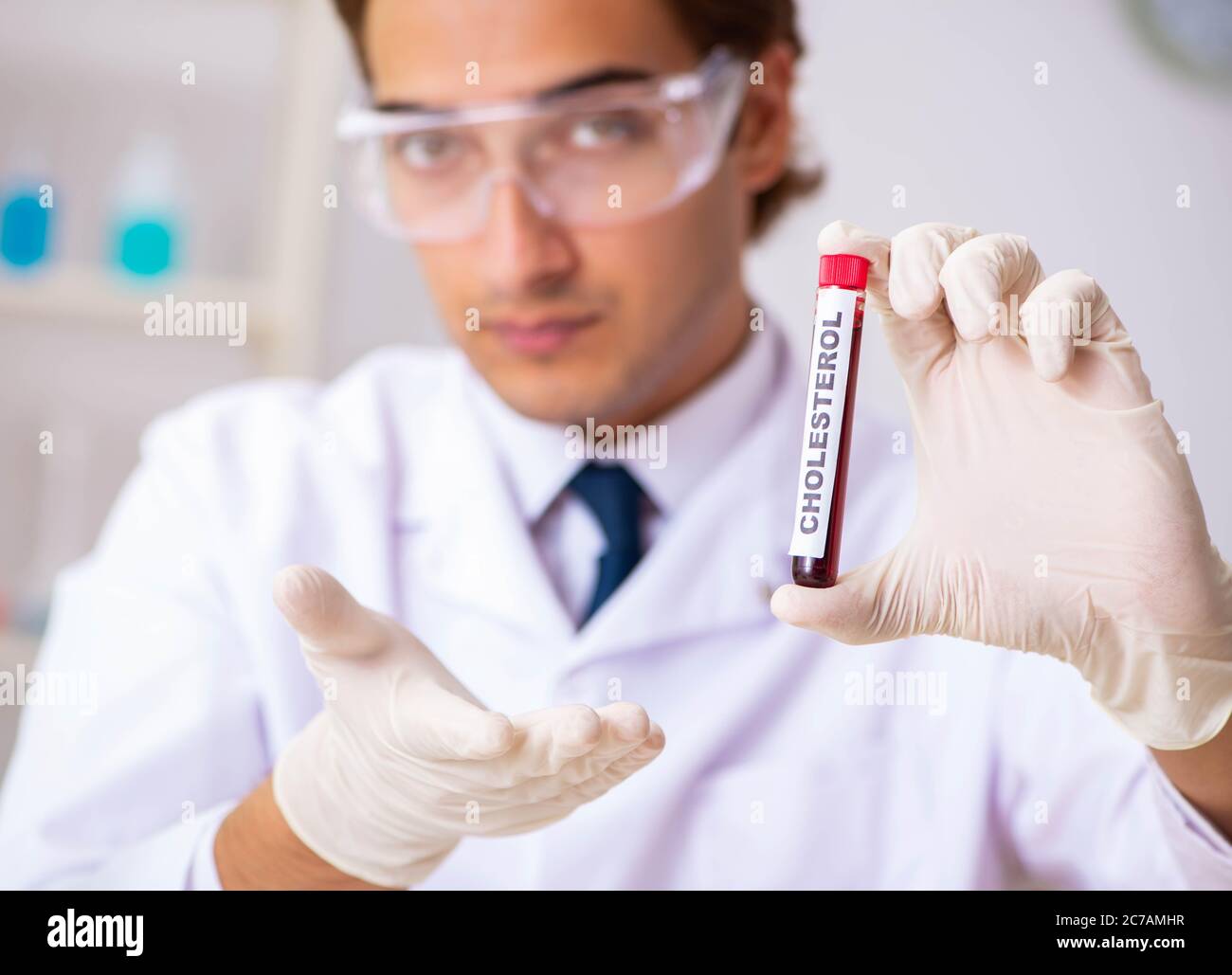 The young handsome lab assistant testing blood samples in hospital ...