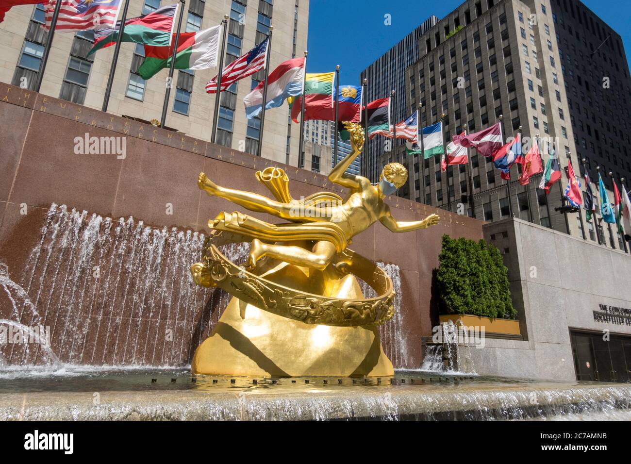 Prometheus in Rockefeller Center features a giant face mask because of ...