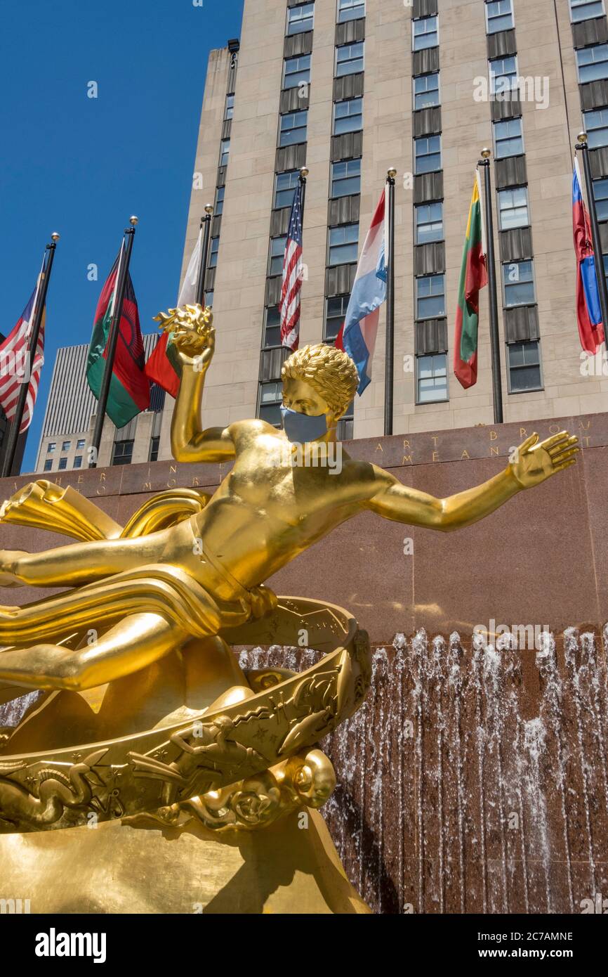 Prometheus in Rockefeller Center features a giant face mask because of ...