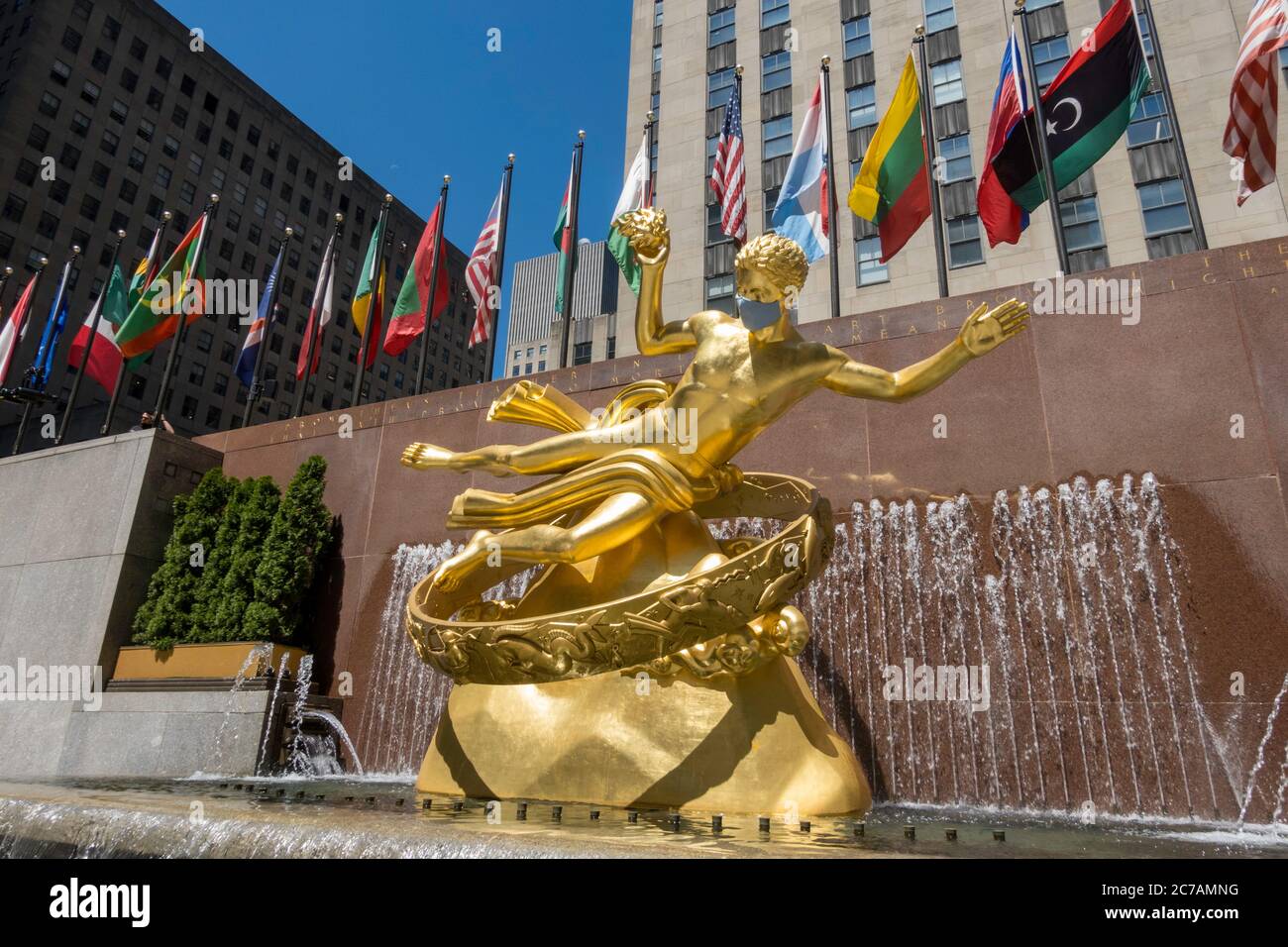 Prometheus in Rockefeller Center features a giant face mask because of ...