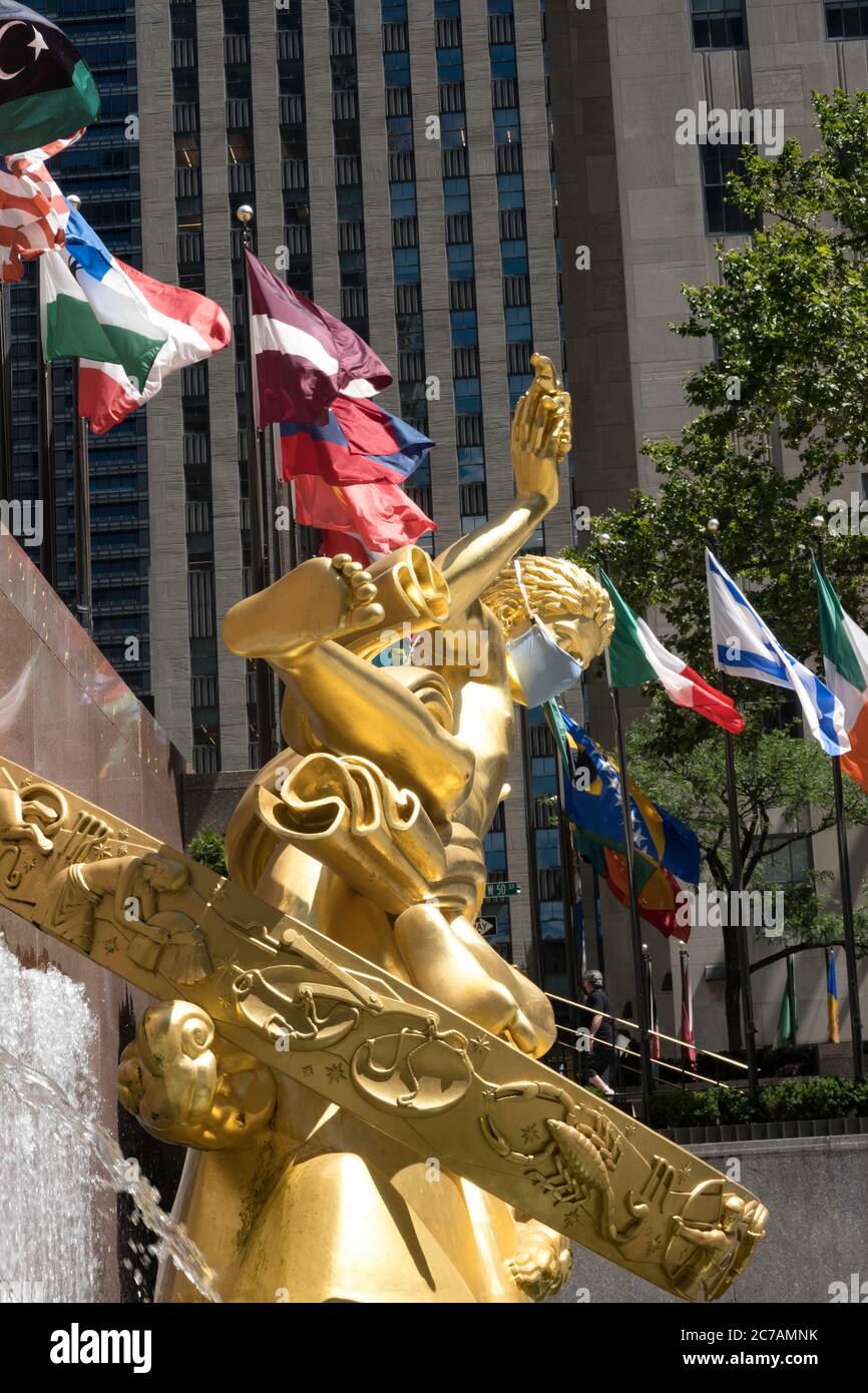 Prometheus in Rockefeller Center features a giant face mask because of ...