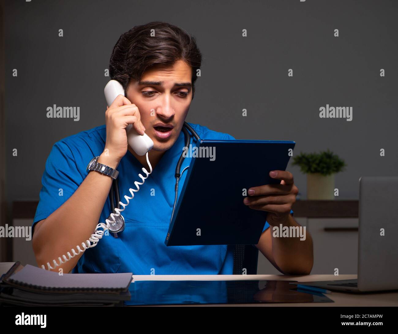 The young handsome doctor working night shift in hospital Stock Photo ...