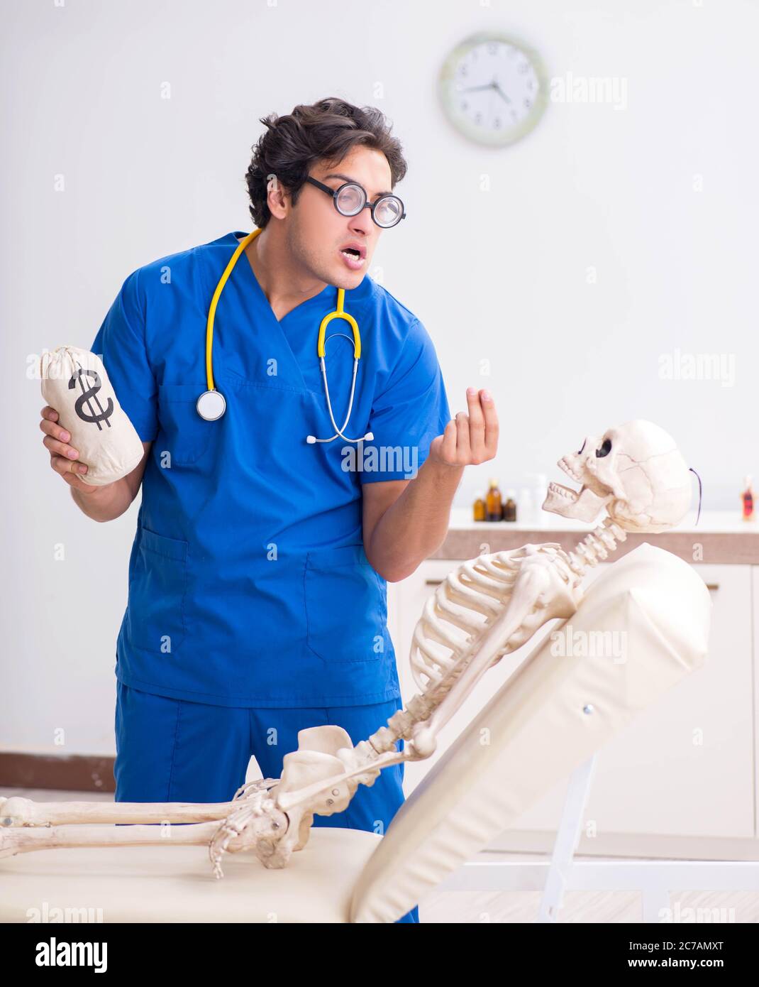 The funny doctor with skeleton in hospital Stock Photo - Alamy