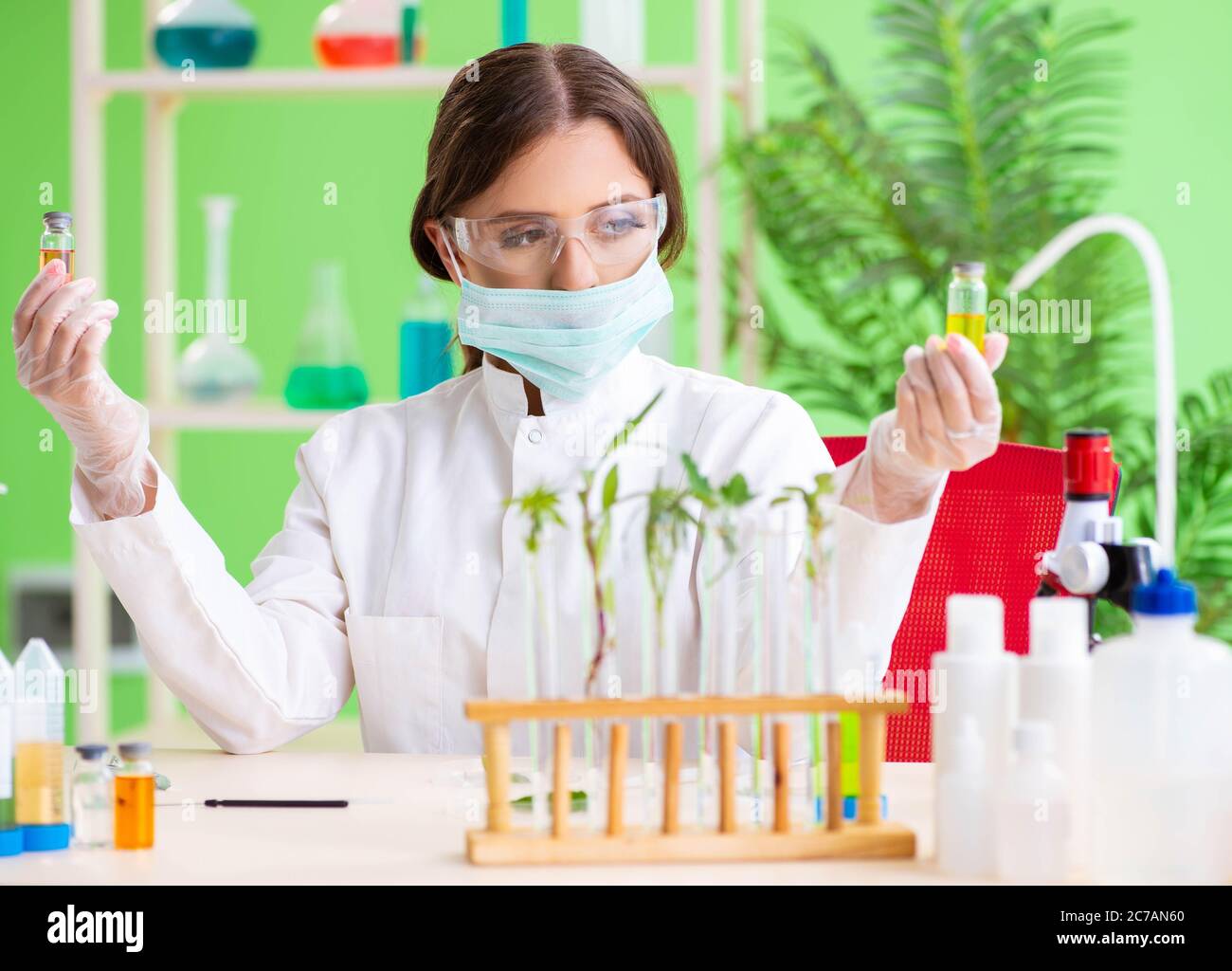 The beautiful female biotechnology scientist chemist working in lab ...