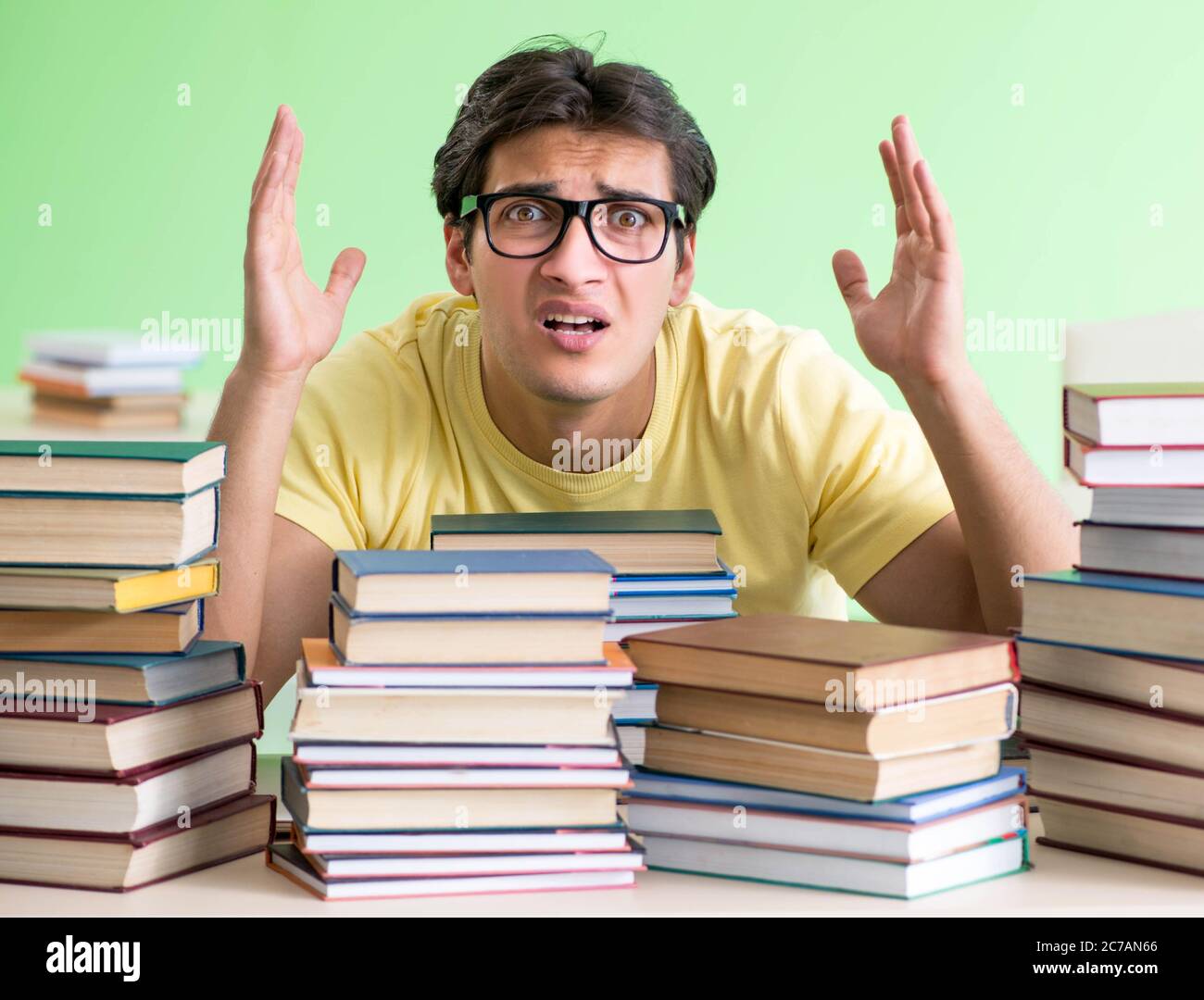 The student with too many books to read before exam Stock Photo - Alamy