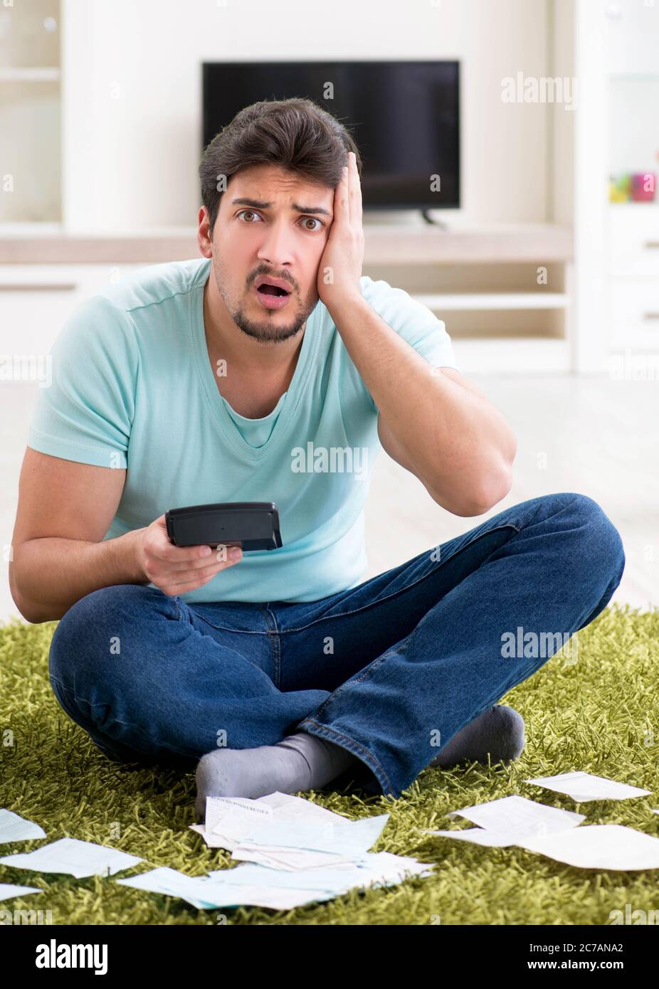 The young man struggling with personal finance and bills Stock Photo ...