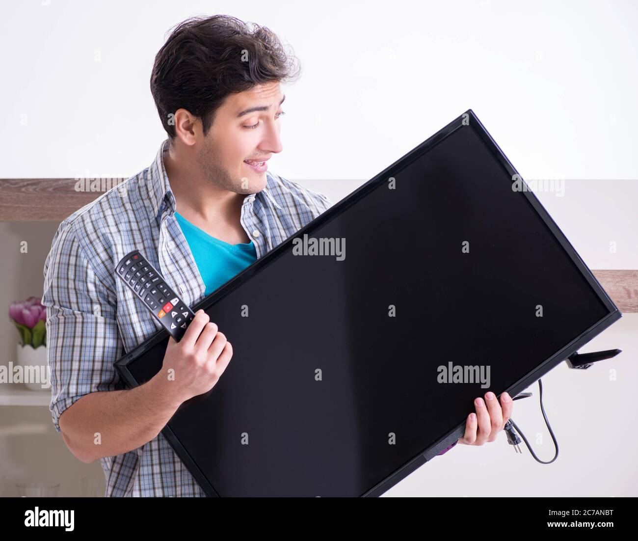 The man trying to fix broken tv Stock Photo - Alamy