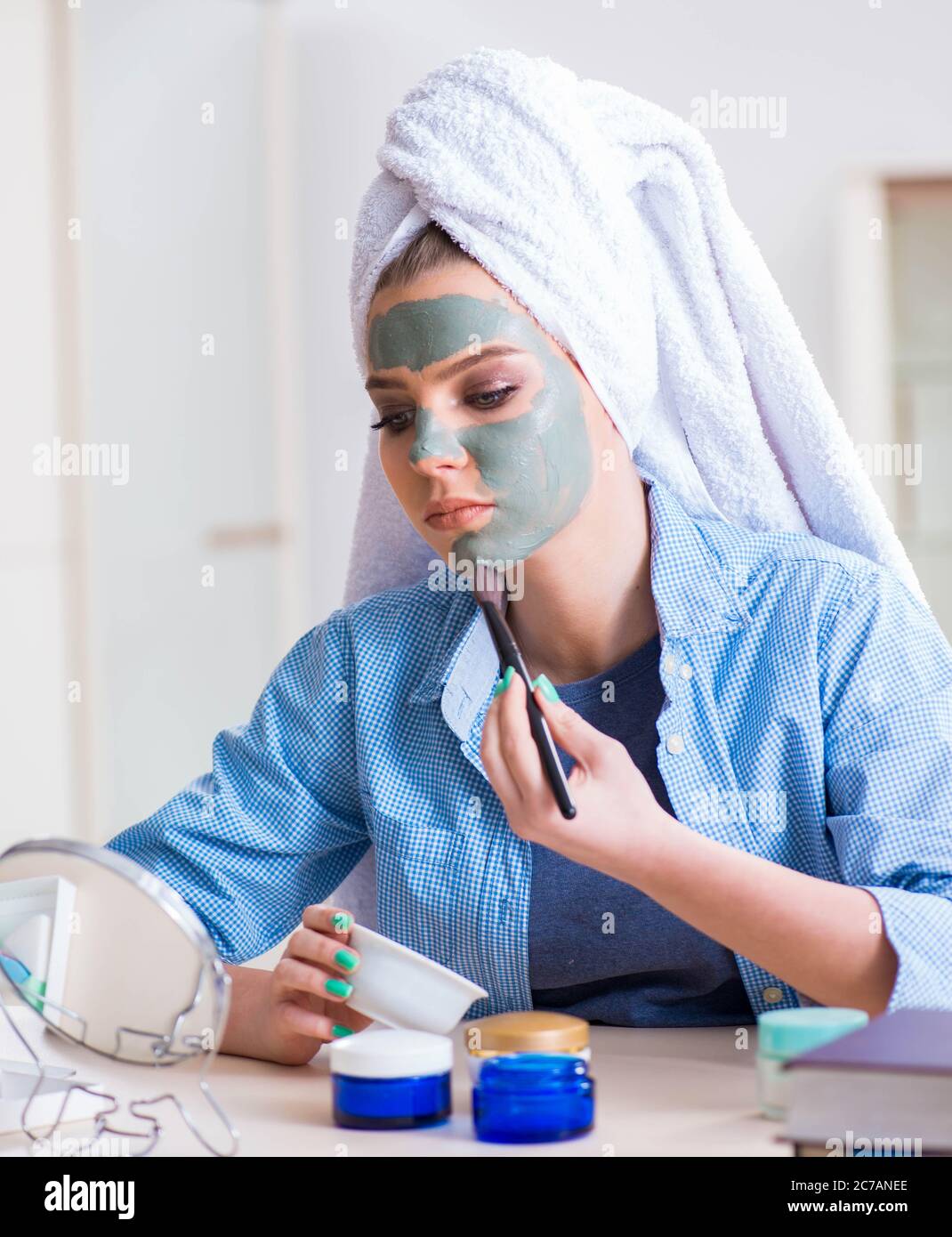 The woman applying clay mask with brush at home Stock Photo - Alamy