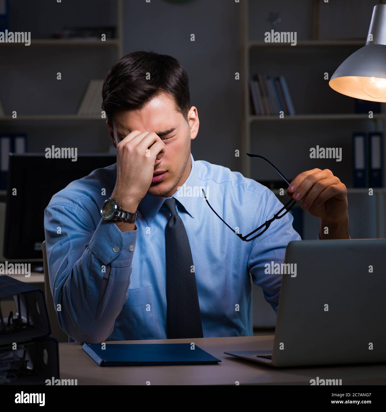 The employee working late at night at important report Stock Photo - Alamy