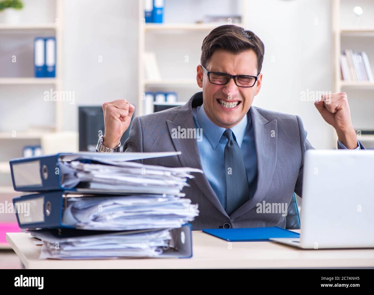 The overloaded with work employee under paperwork burden Stock Photo ...