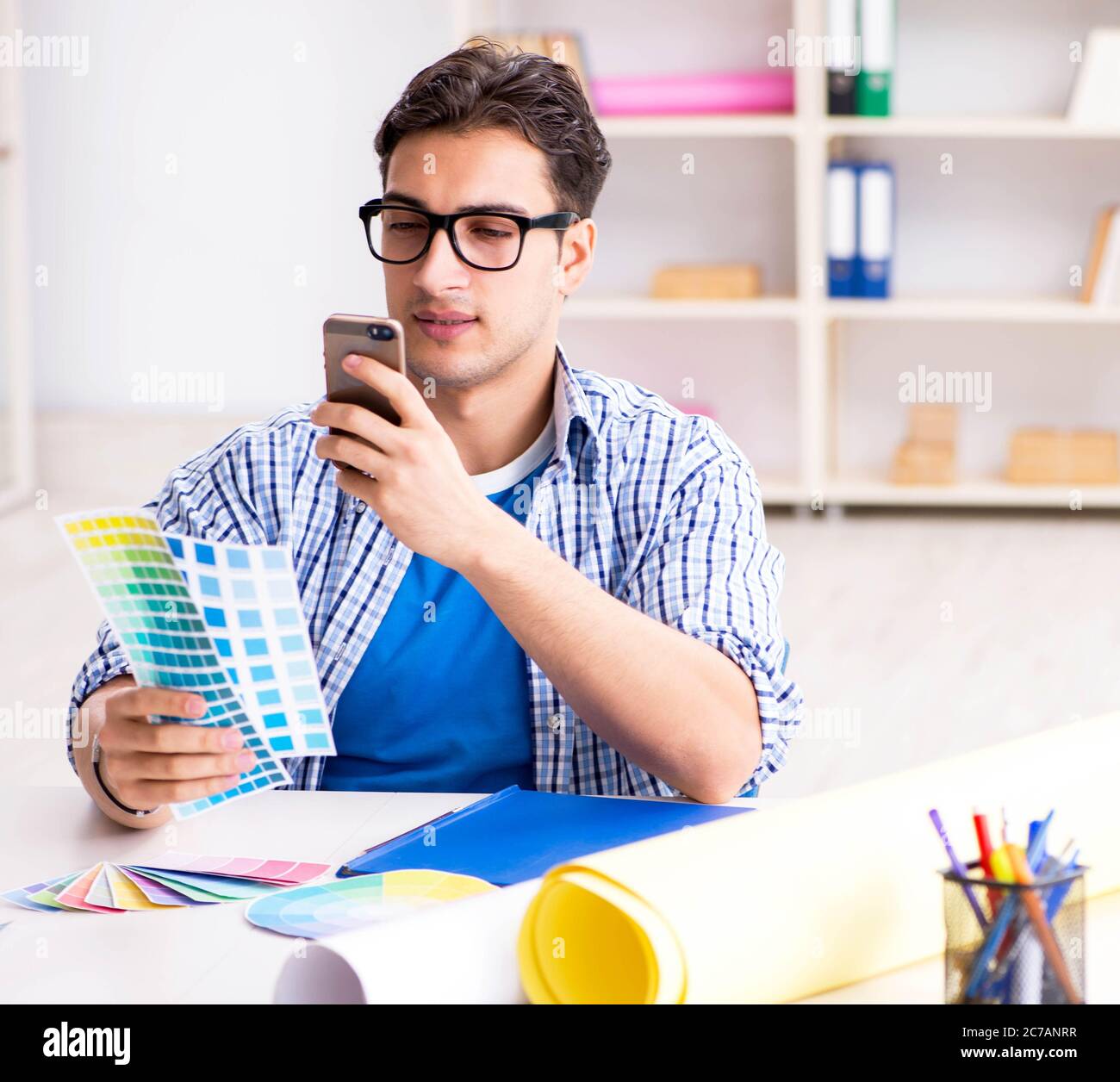 The young designer working on new project and choosing colours Stock ...