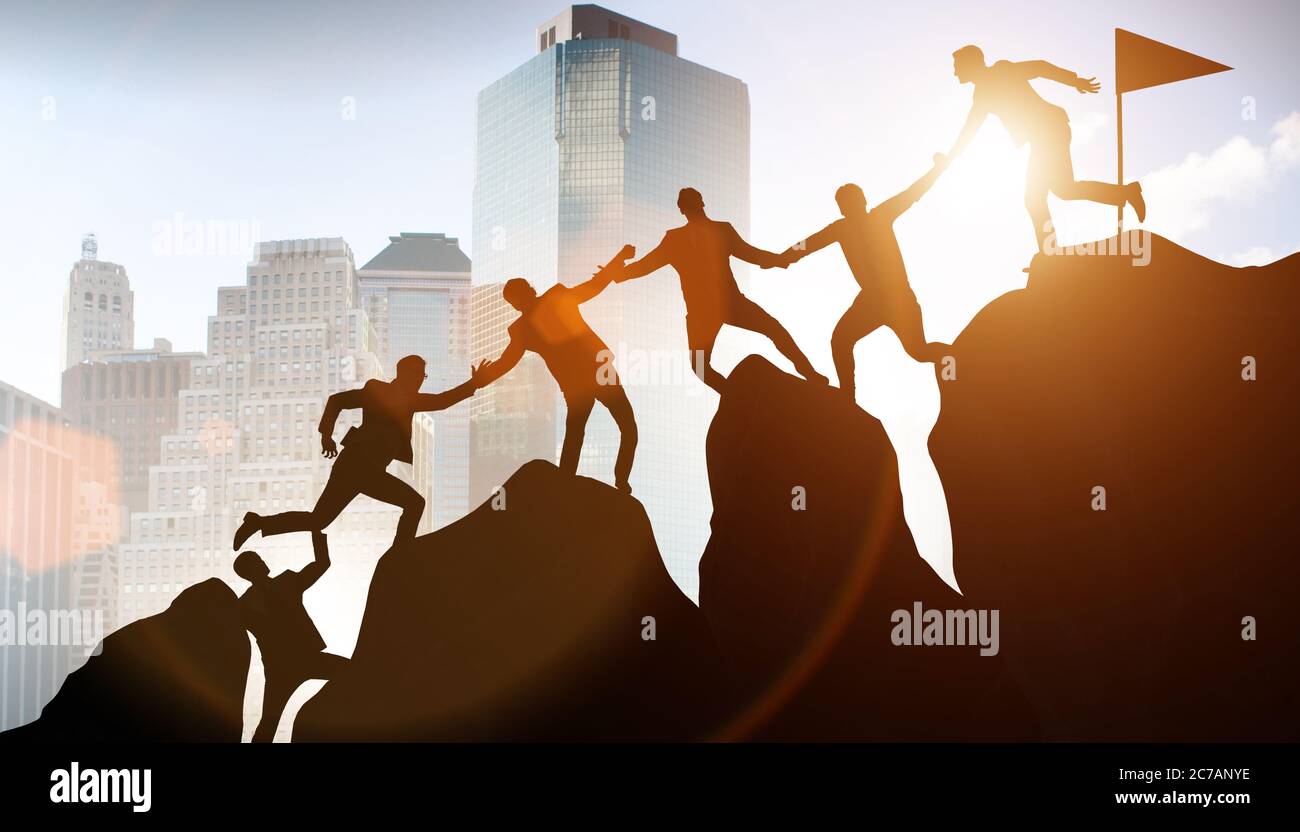 Concept of teamwork with the team climbing mountain top Stock Photo - Alamy