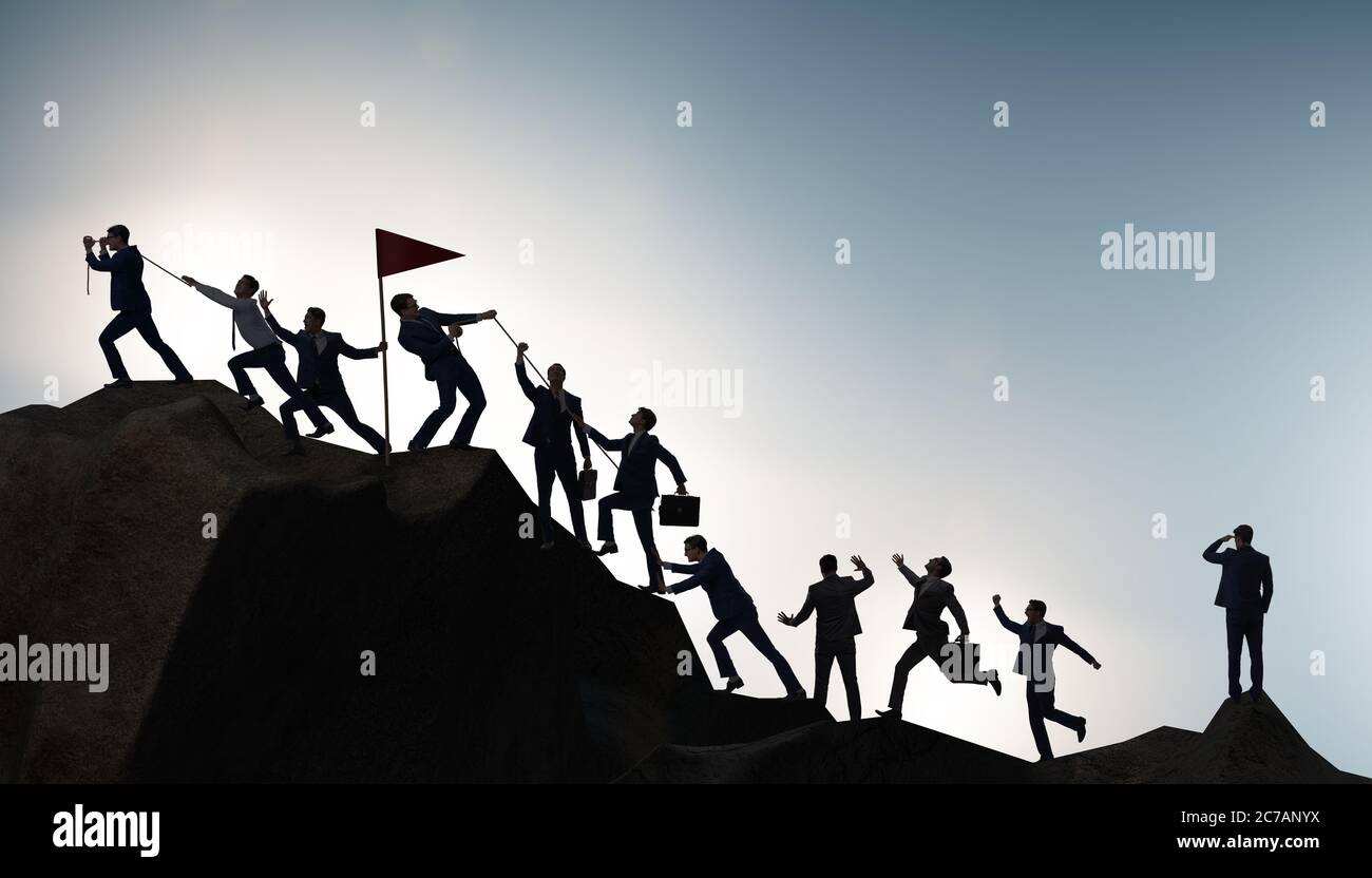 Concept of teamwork with team climbing mountain Stock Photo - Alamy