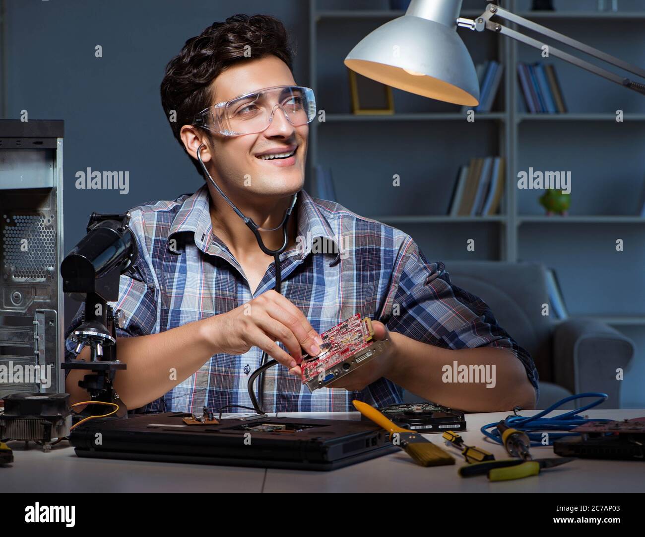 The computer repair concept with man inspecting with stethoscope Stock ...