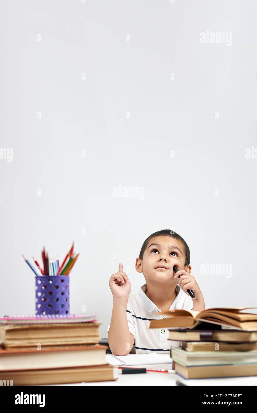 Thoughtful schoolboy having idea, raising finger. I know it. Primary ...
