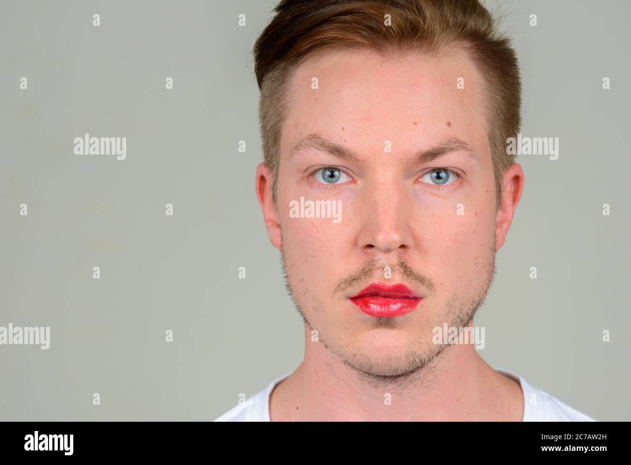 Portrait of young man with beard stubble wearing makeup Stock Photo - Alamy