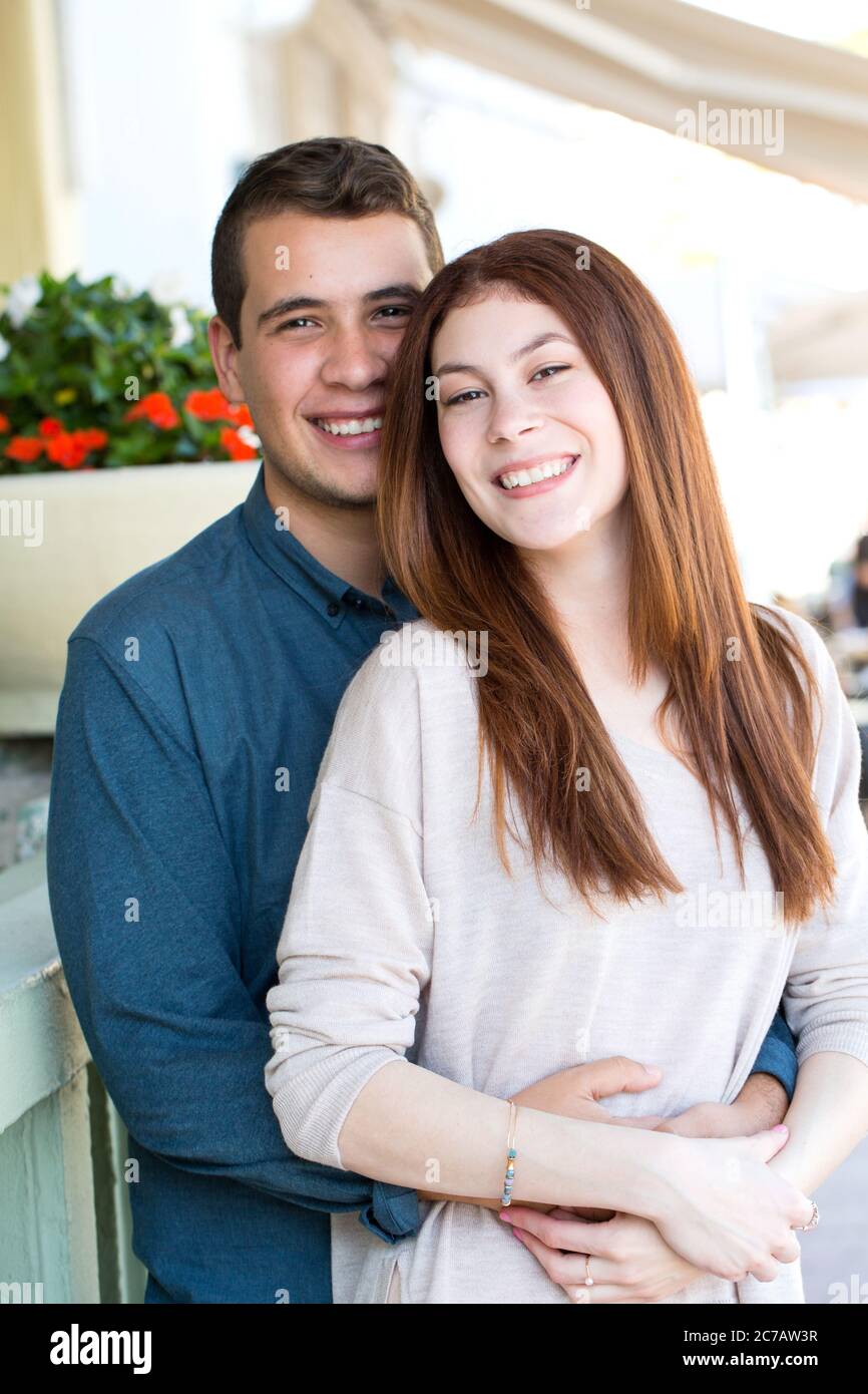 Young happy Latin couple hugging and smiling Stock Photo - Alamy