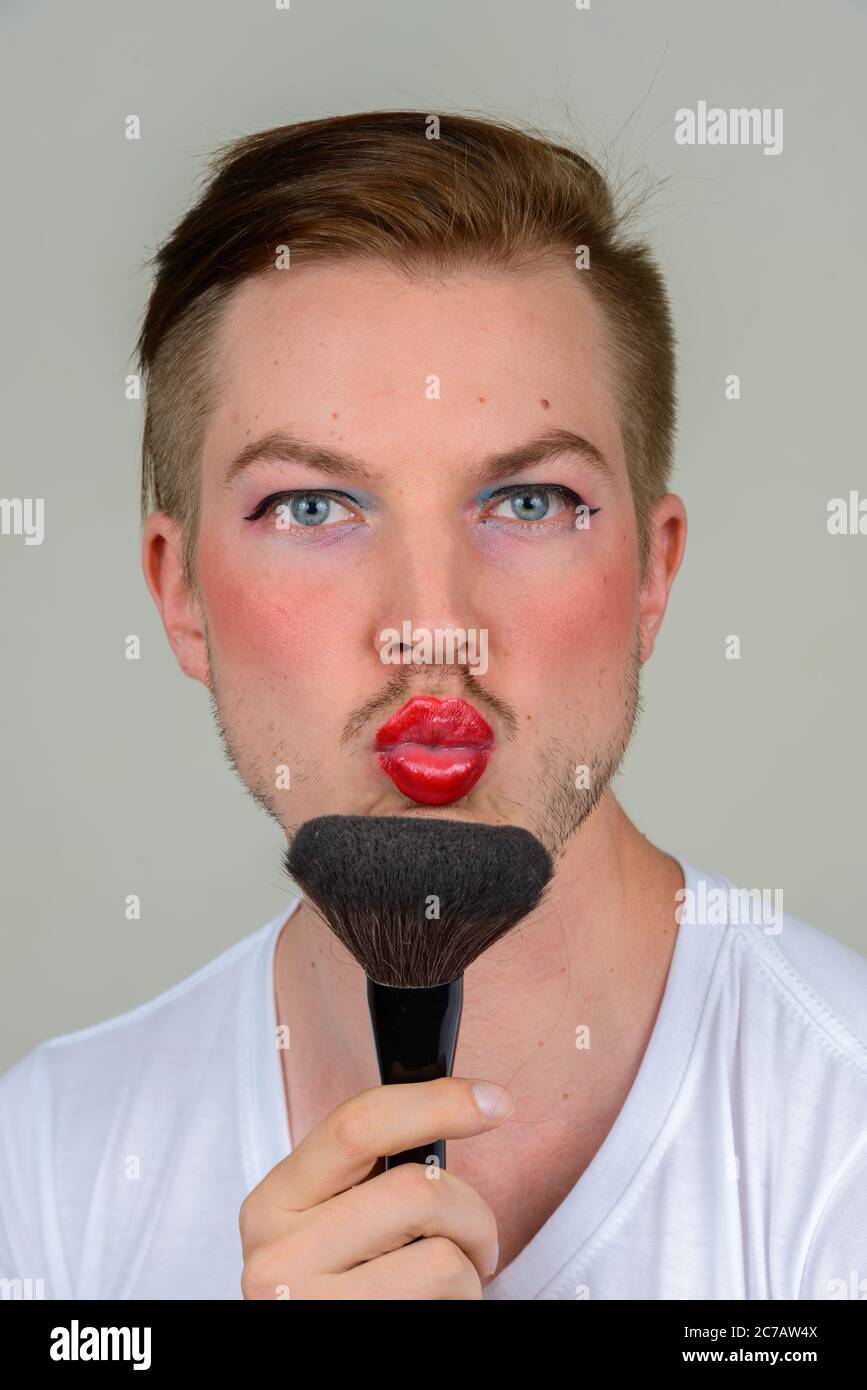 Portrait of young man with beard stubble wearing makeup Stock Photo - Alamy