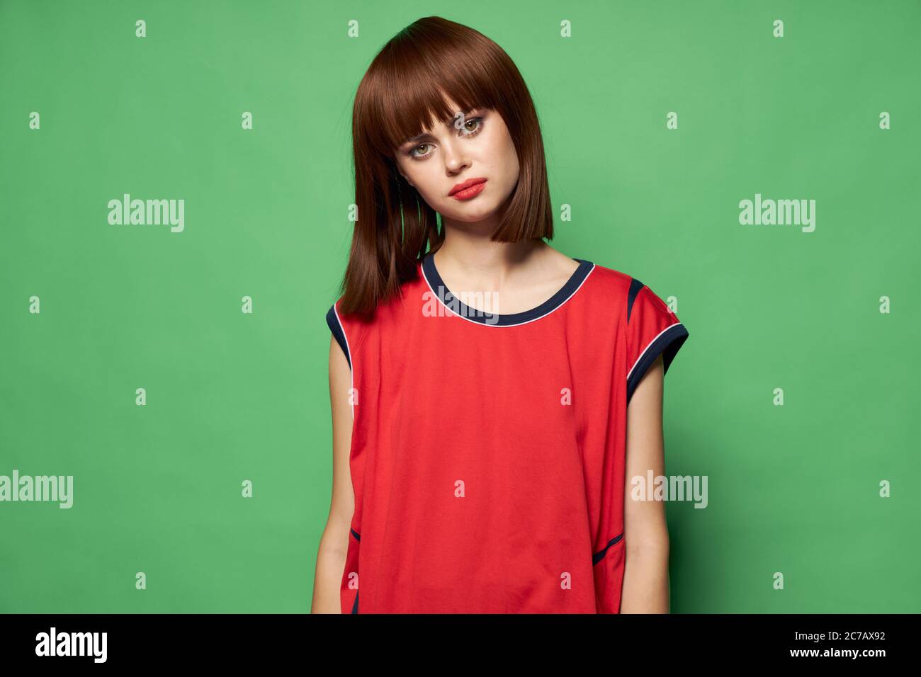 sad woman tilted her head to the side against a green background free ...