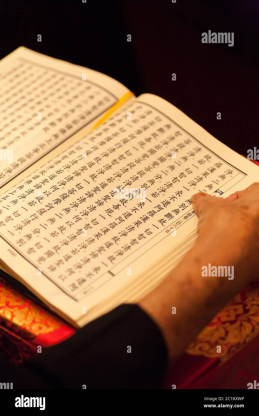 Vertical close up image of a buddhism ritual or mantra book. Singapore ...