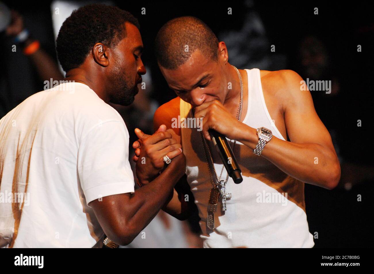 Rappers Clifford Harris Jr. aka T.I. and Kanye West (L) perform at a ...